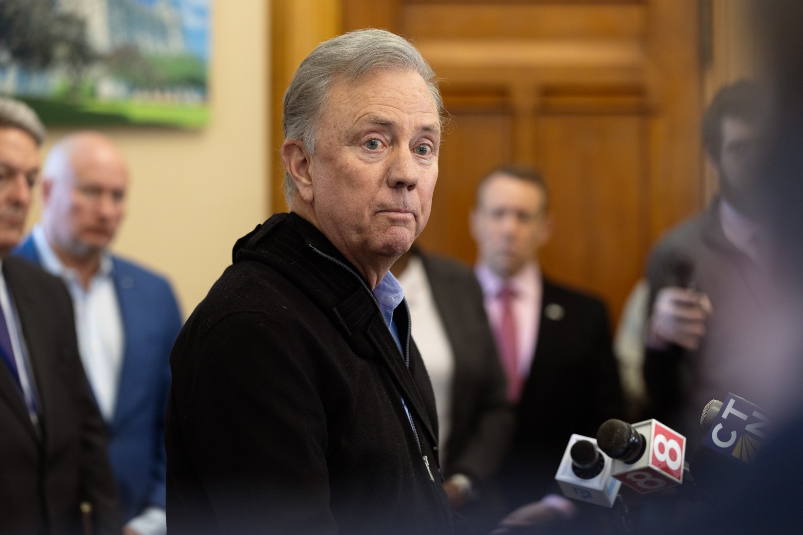 Lamont returns from India with broken arm and a veto plan