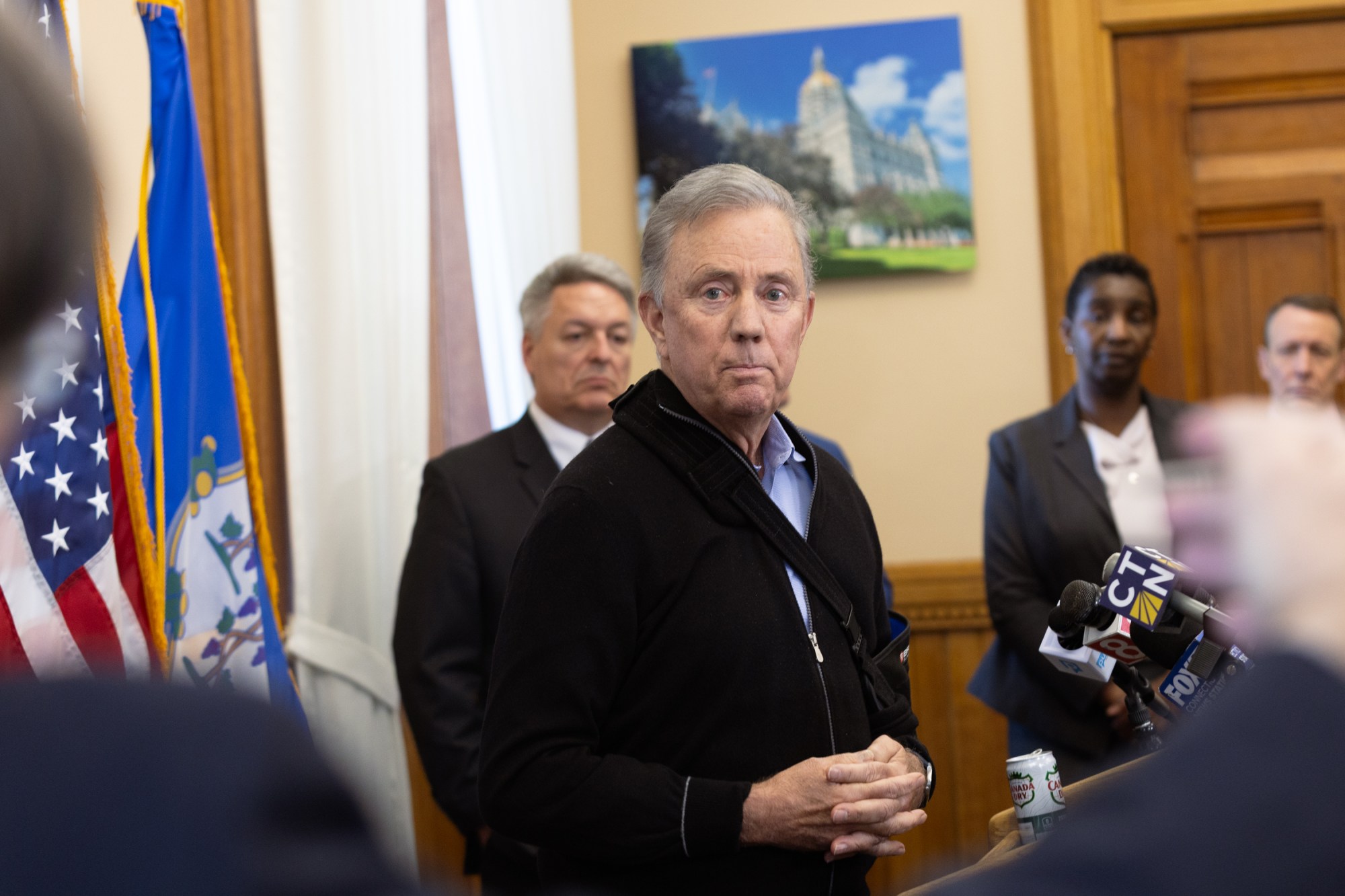 Lamont returns from India with broken arm and a veto plan